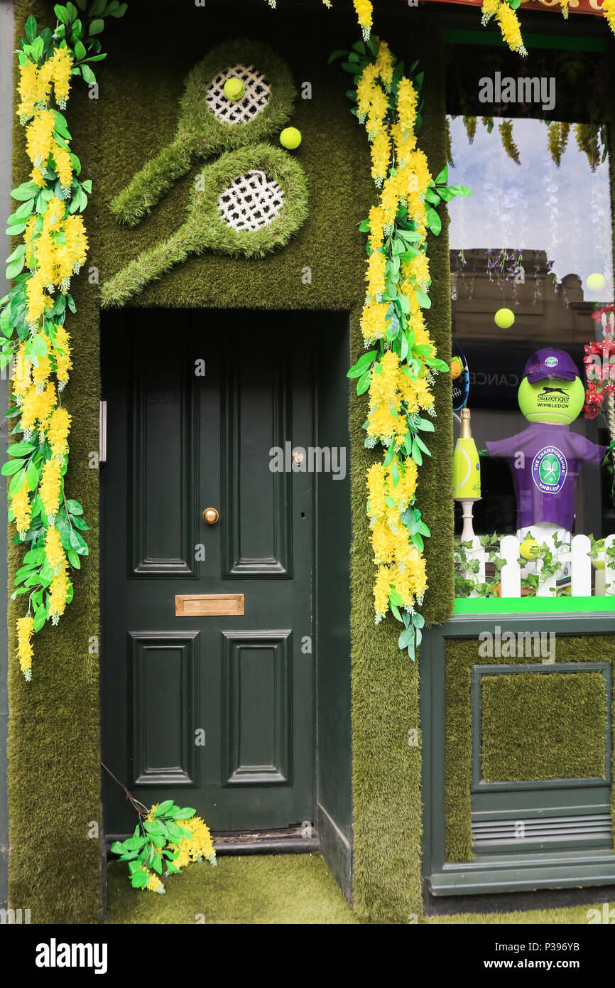 London UK. 18th June 2018. Wimbledon Shopkeepers decorate their windows ...