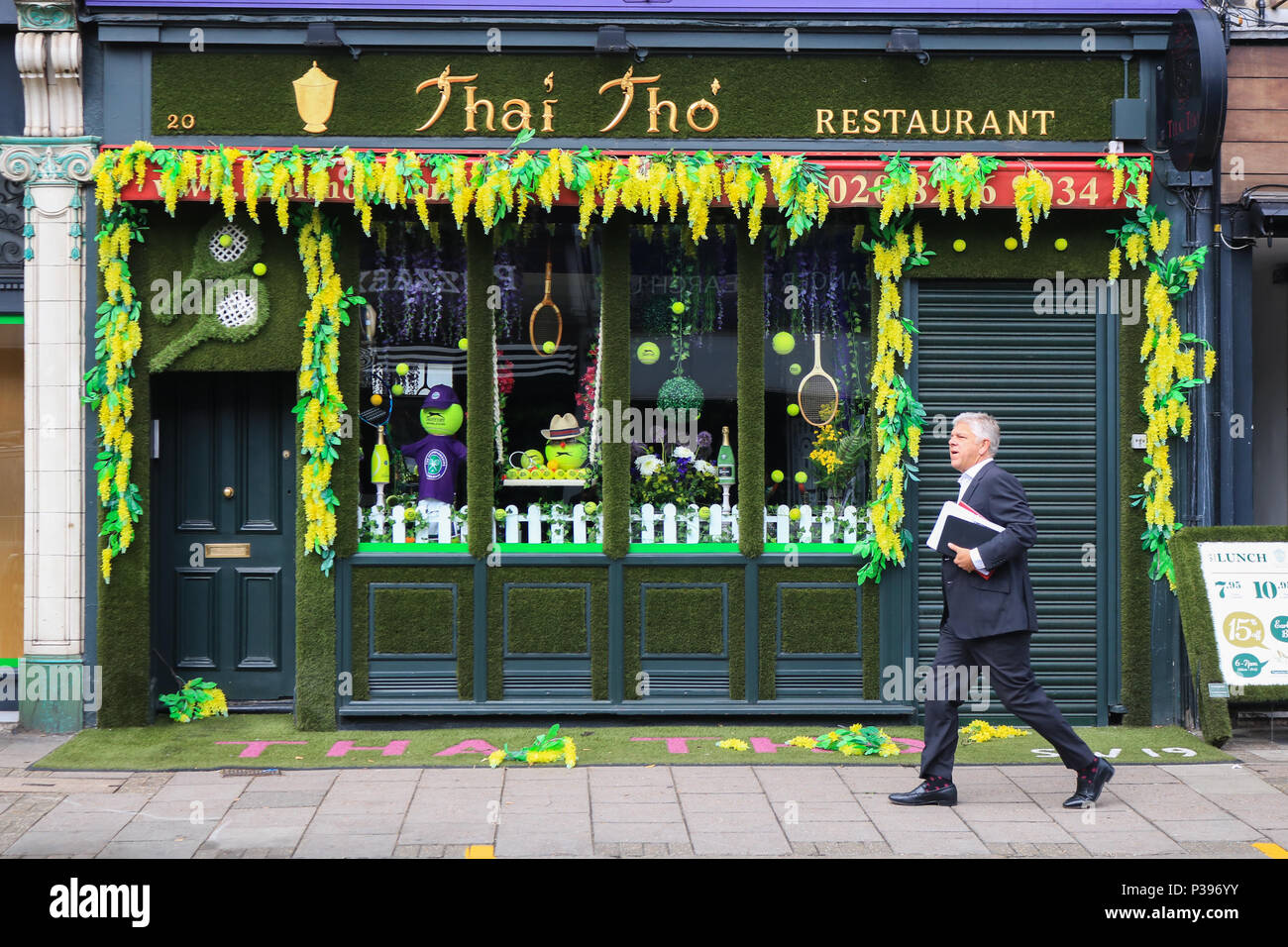 London UK. 18th June 2018. Wimbledon Shopkeepers decorate their windows ...