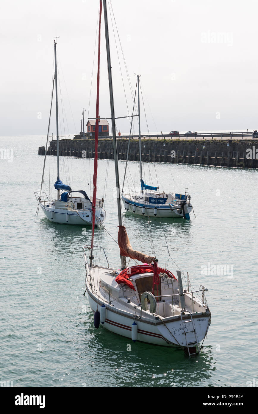 Three sailing yachts at anchor in the outer harbour at Folkestone, Kent ...