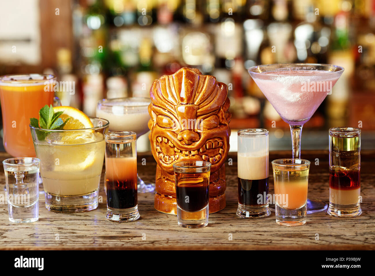 mix of cocktails in a nightclub, stand in a row on a bar counter on a ...