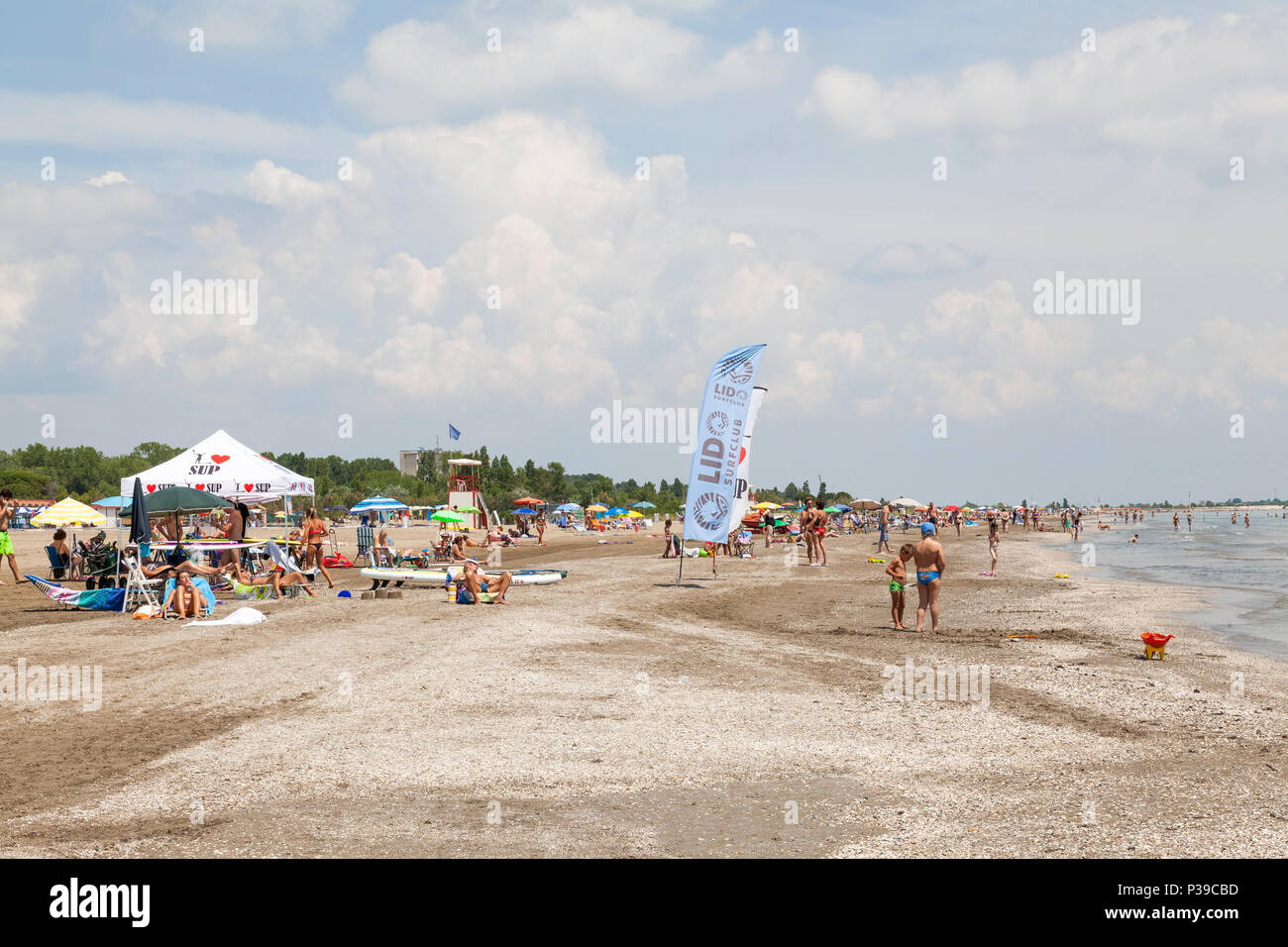 Lido Surf Club sign and colourful umbrellas on a beach on Lido di ...