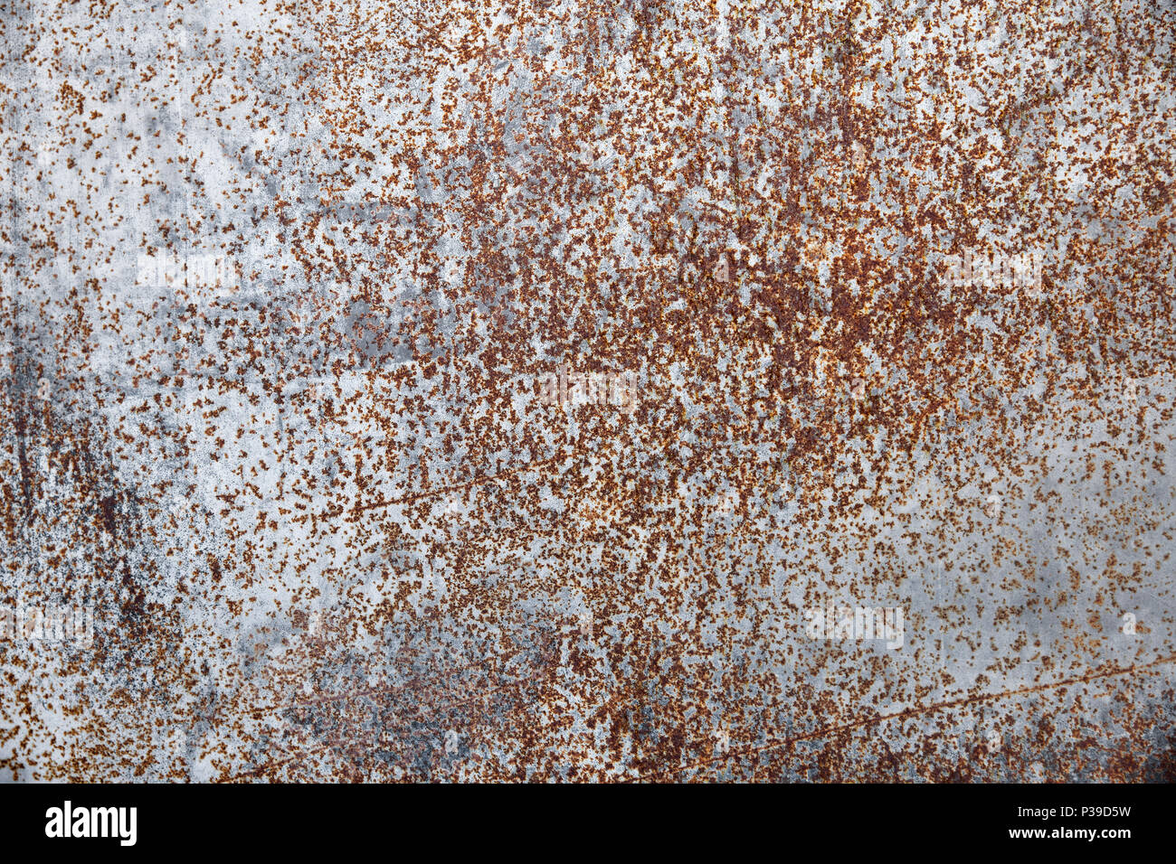 textured grey corroded metal surface with flecks of rust Stock Photo ...