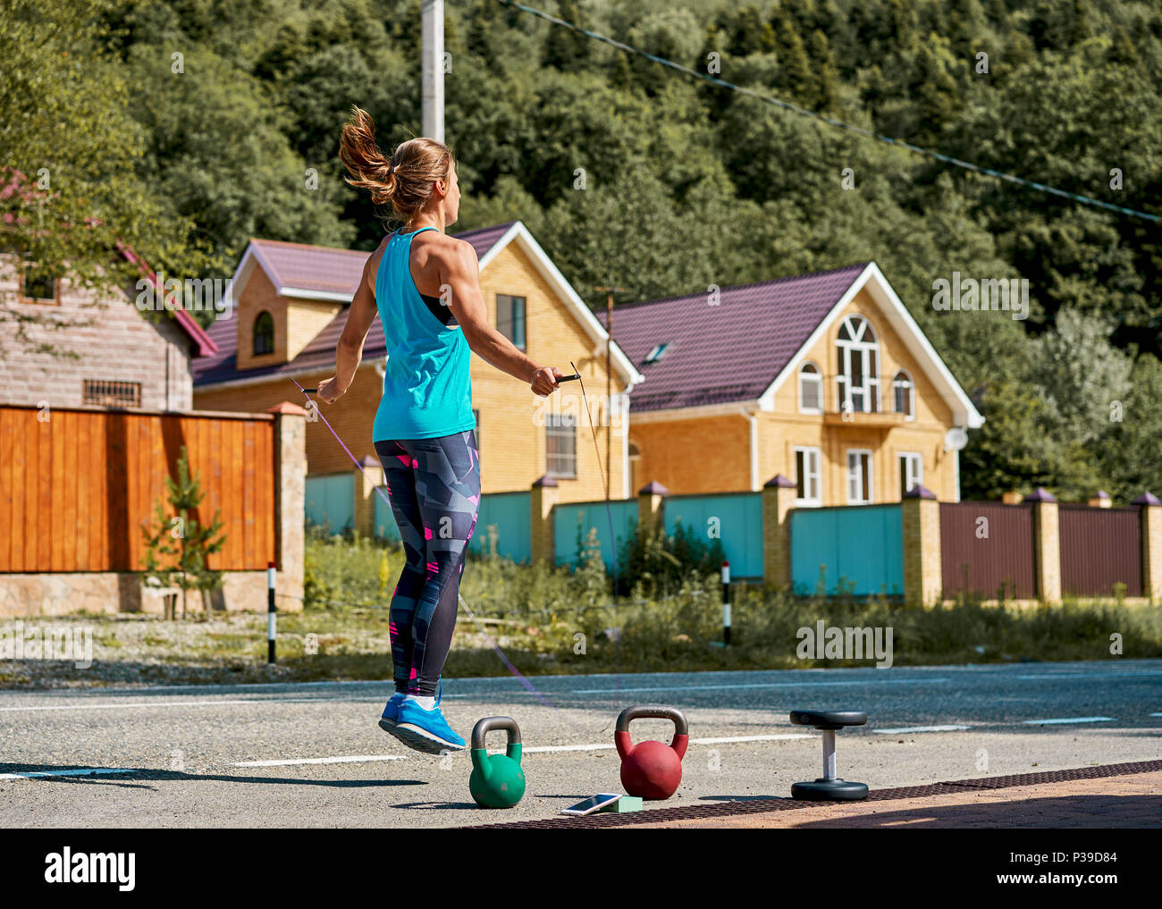 athlete jumping on a rope in the street Stock Photo - Alamy