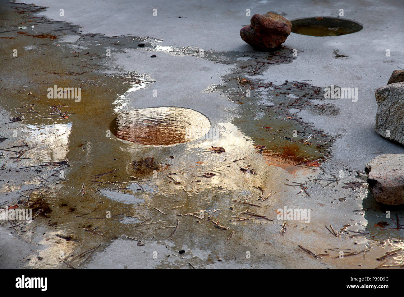 background wet holes with reflections on dry fountain water Stock Photo ...