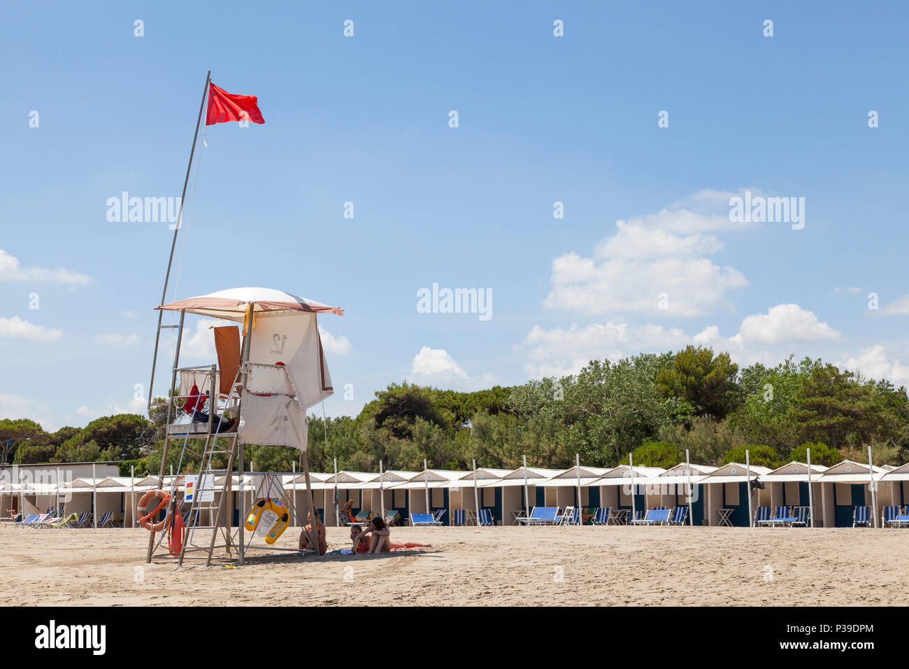 Lifeguard lookout and beach huts, cabanas, on a sandy beach Lido di ...