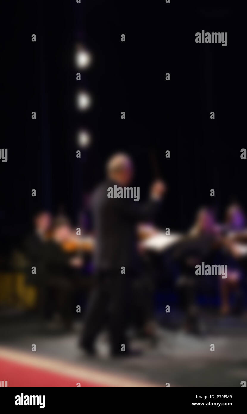 Orchestra conductor manages the orchestra. musical concept. blurred ...