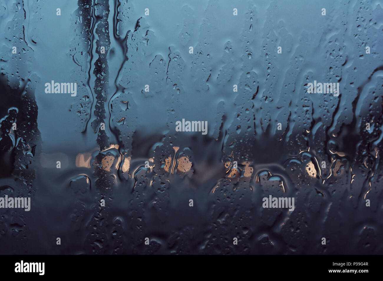 Heavy rain streaming down a windshield in rush hour traffic Stock Photo ...