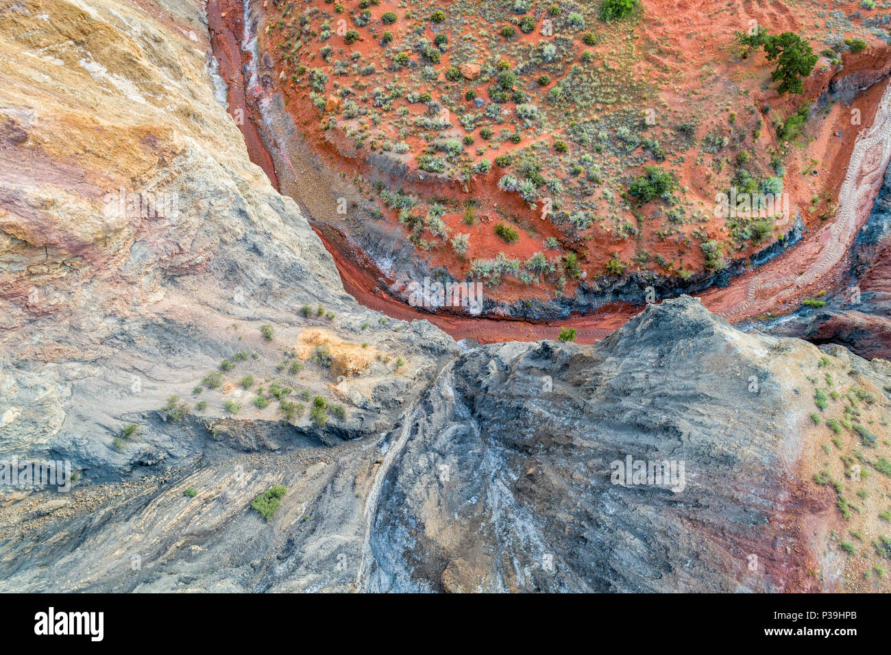 Aerial view of colorful rock formation and steep cliff along Onion ...