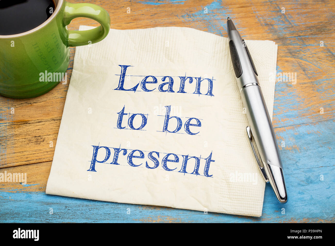 Learn to be present - inspirational handwriitng on napkin with a cup of ...