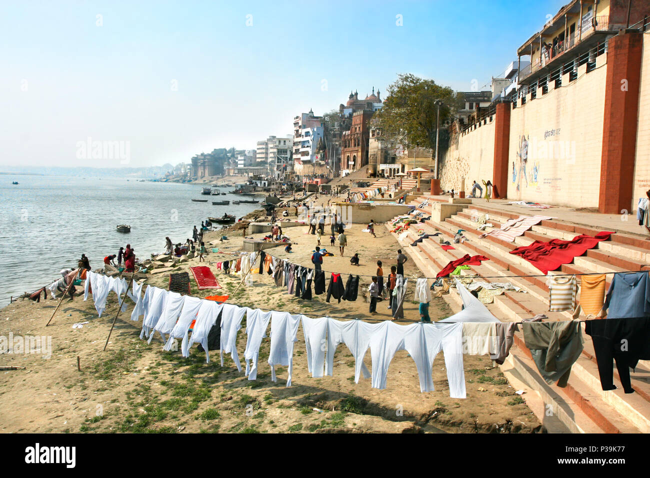 VARANASI, INDIA - FEBRUARY 10: People drying clothes on a bank of ...