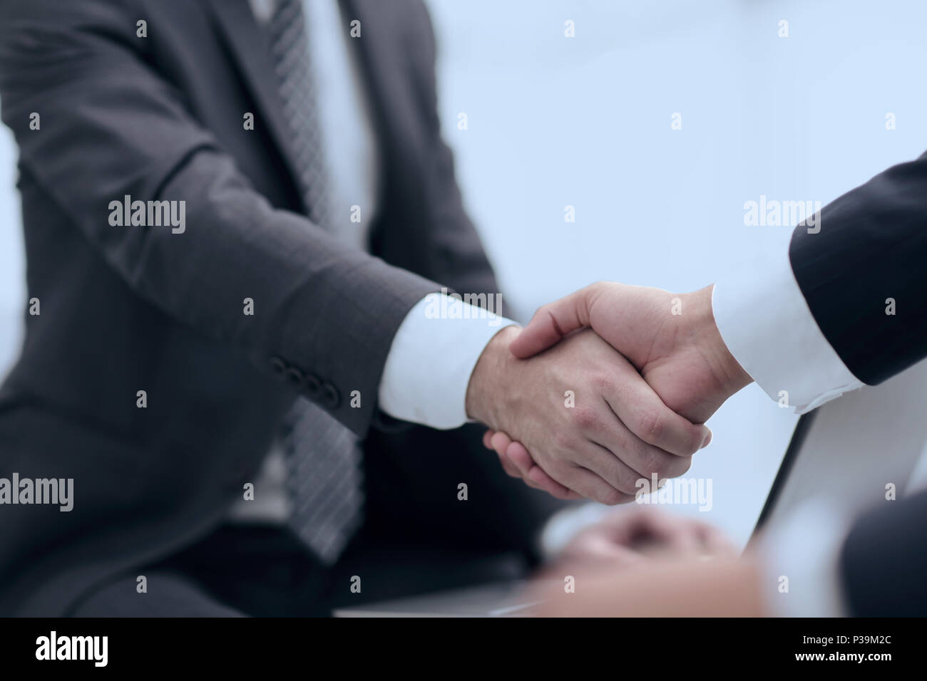 Closeup of business people shaking hands over a deal Stock Photo - Alamy