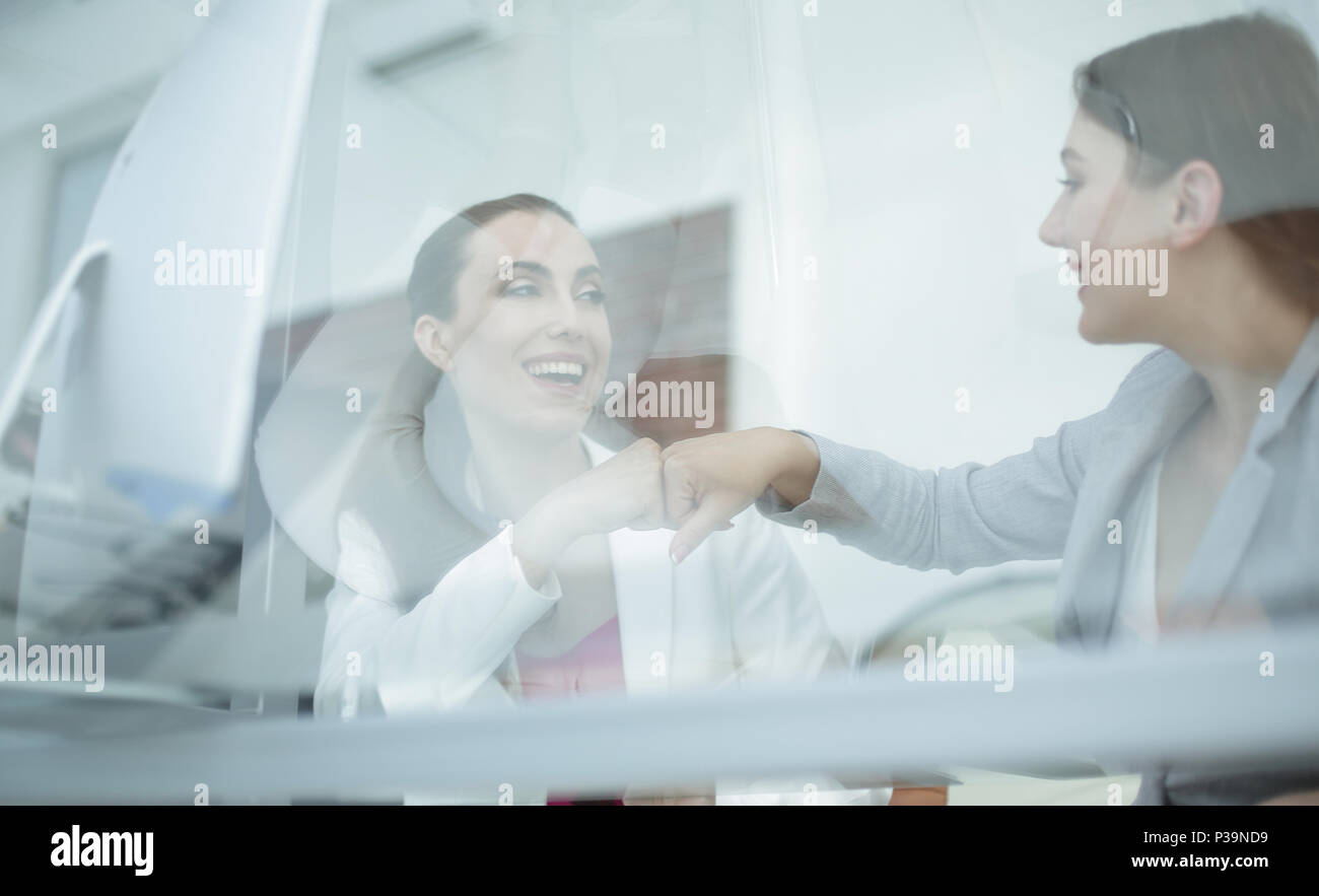 behind the glass.colleagues celebrate their success Stock Photo - Alamy