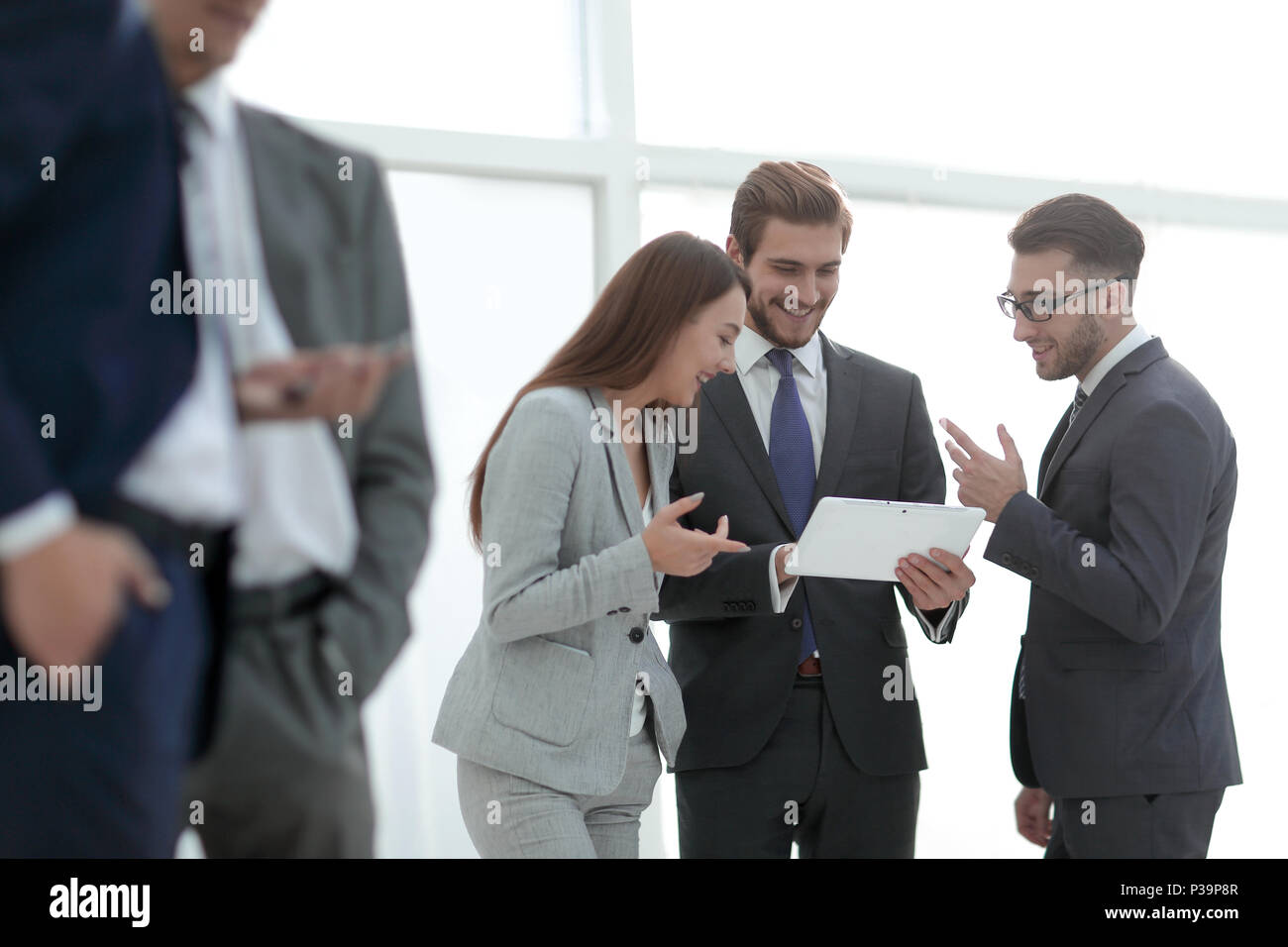 Business people are using gadgets and smiling while working Stock Photo ...