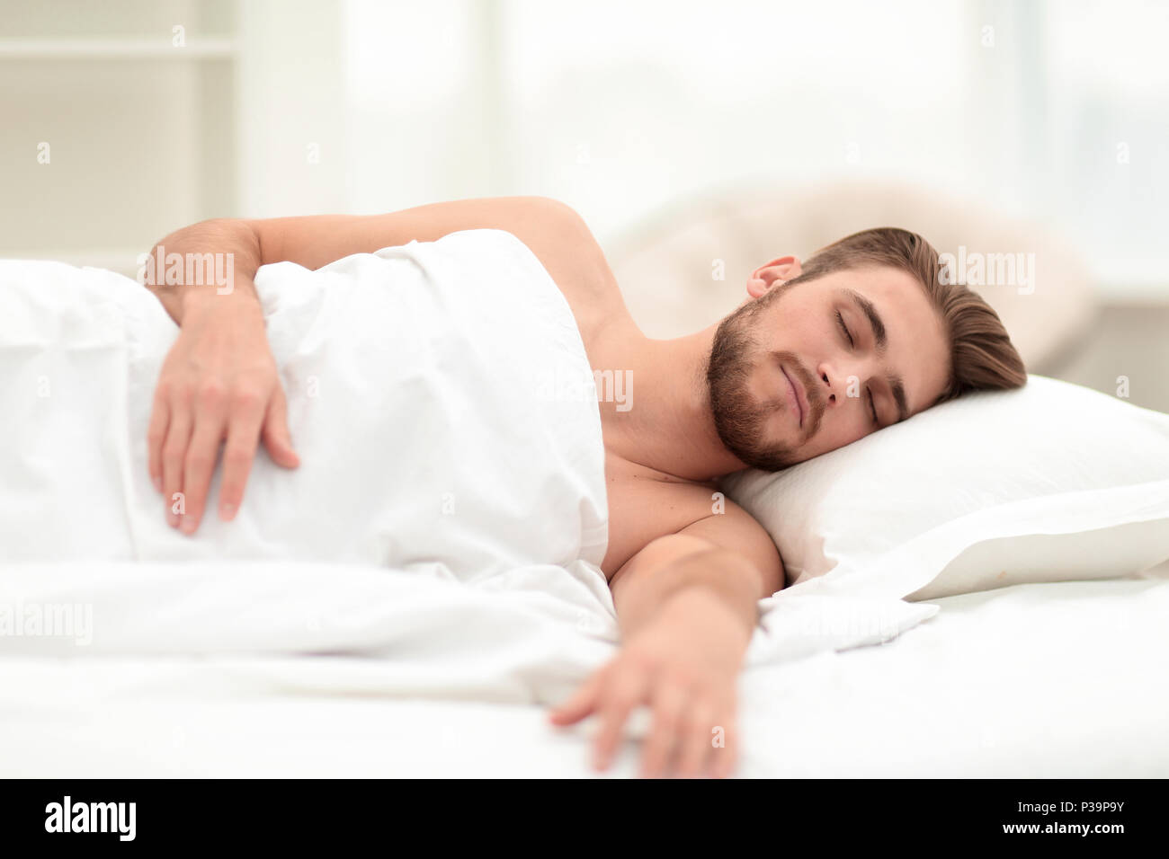 handsome man sleeping in the new bedroom Stock Photo - Alamy