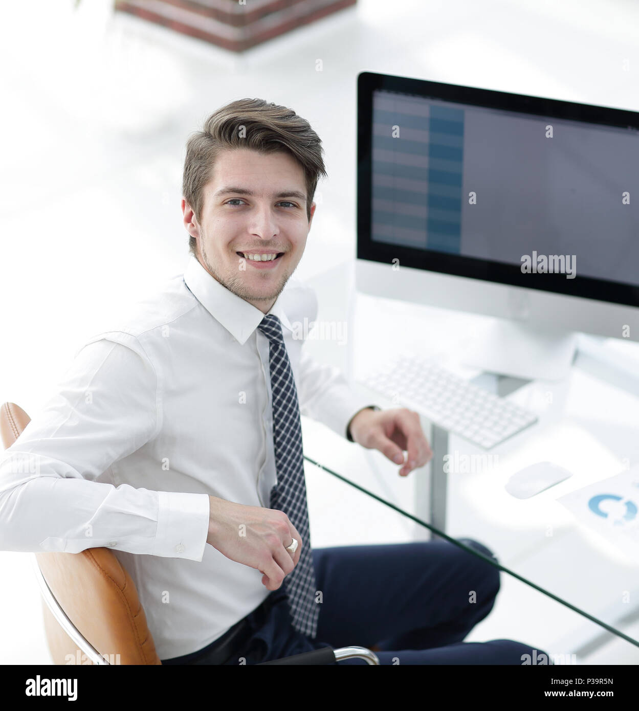 employee sitting in front of a computer screen Stock Photo - Alamy