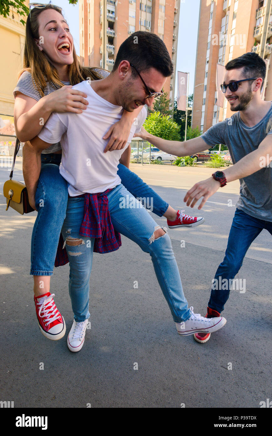 A group of friends walking on the sidewalk in an urban place Stock ...