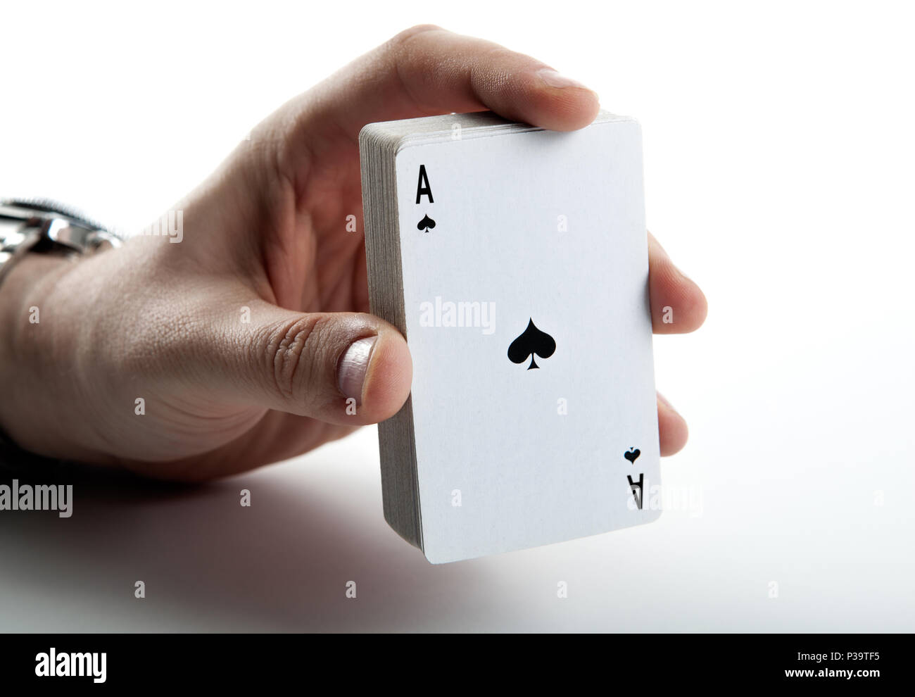 Human hand holding the ace of spades and a deck of cards close up Stock ...