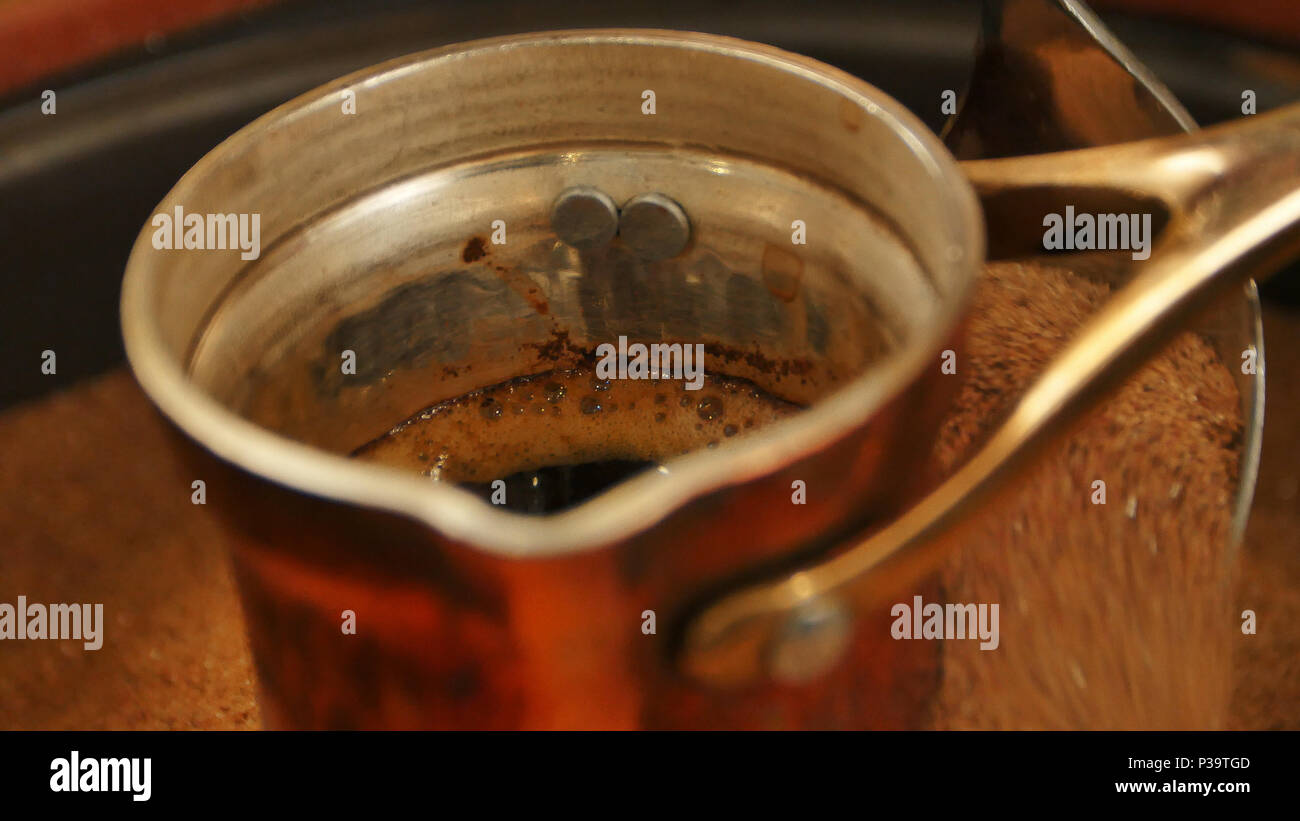 Traditional process boil Turkish coffee in turk Stock Photo - Alamy