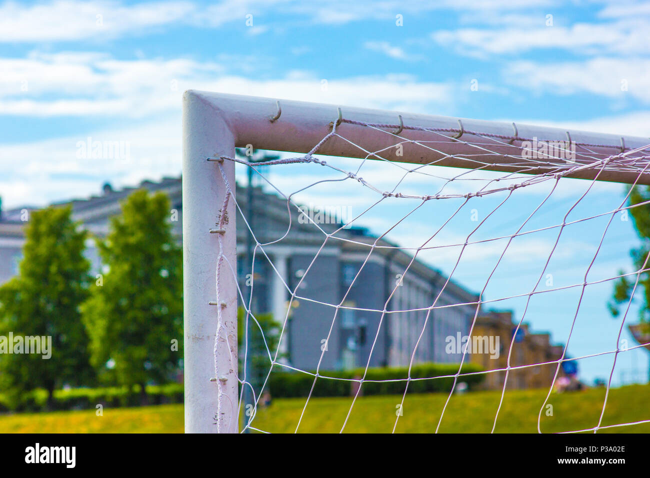 Upper corner of a football gate on a building background and blue sky ...