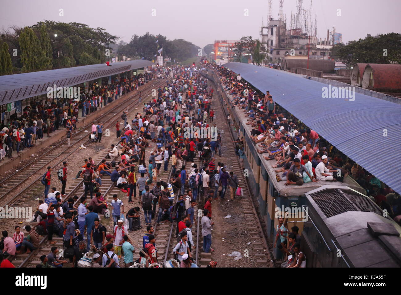 Bangladeshi people rush to homes on an overcrowded train to celebrate upcoming Eid-al-Fitr ...