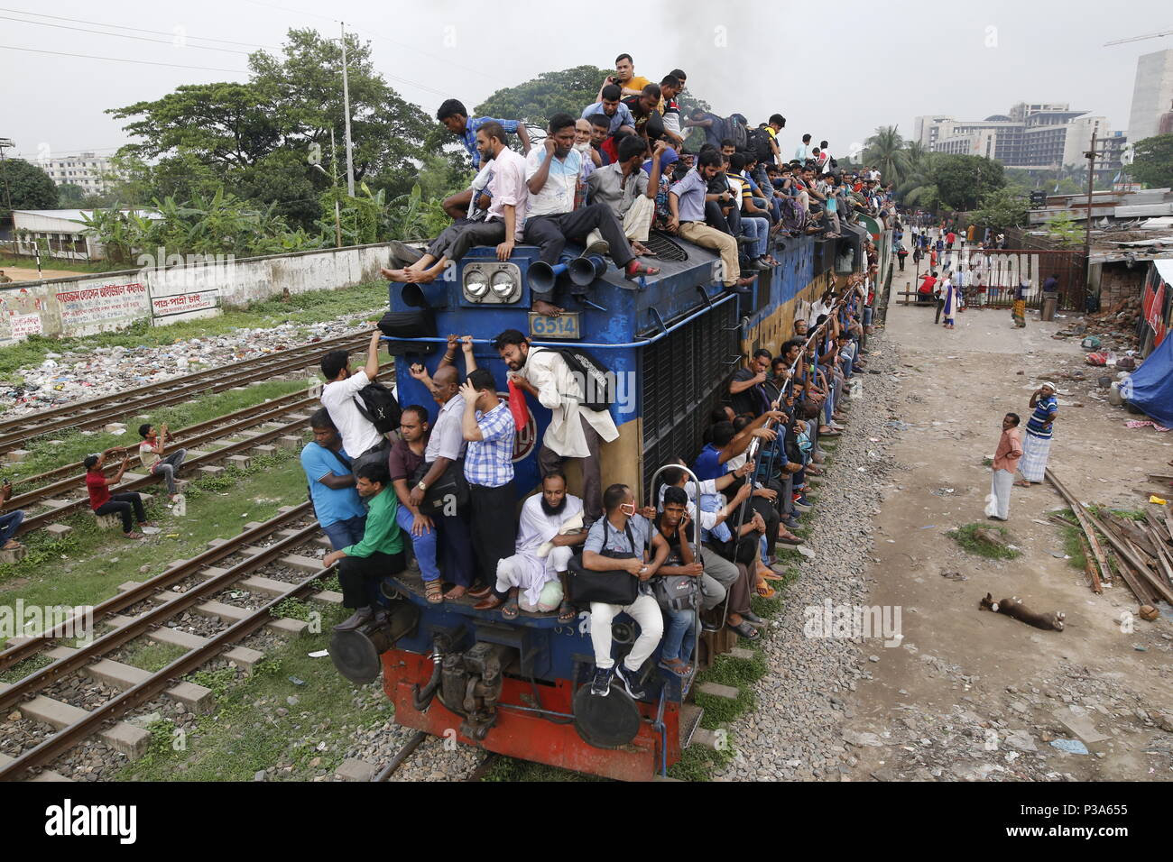Bangladeshi people rush to homes on an overcrowded train to celebrate upcoming Eid-al-Fitr ...