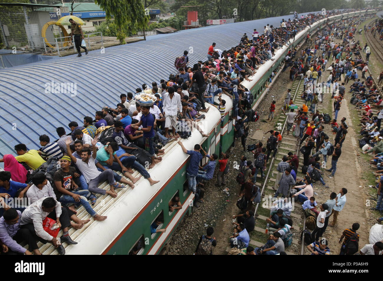 Bangladeshi people rush to homes on an overcrowded train to celebrate upcoming Eid-al-Fitr ...
