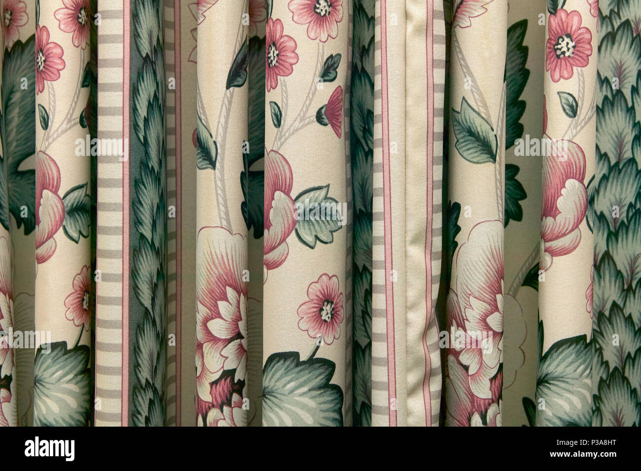 Background texture of folds of floral curtaining material hanging in a ...