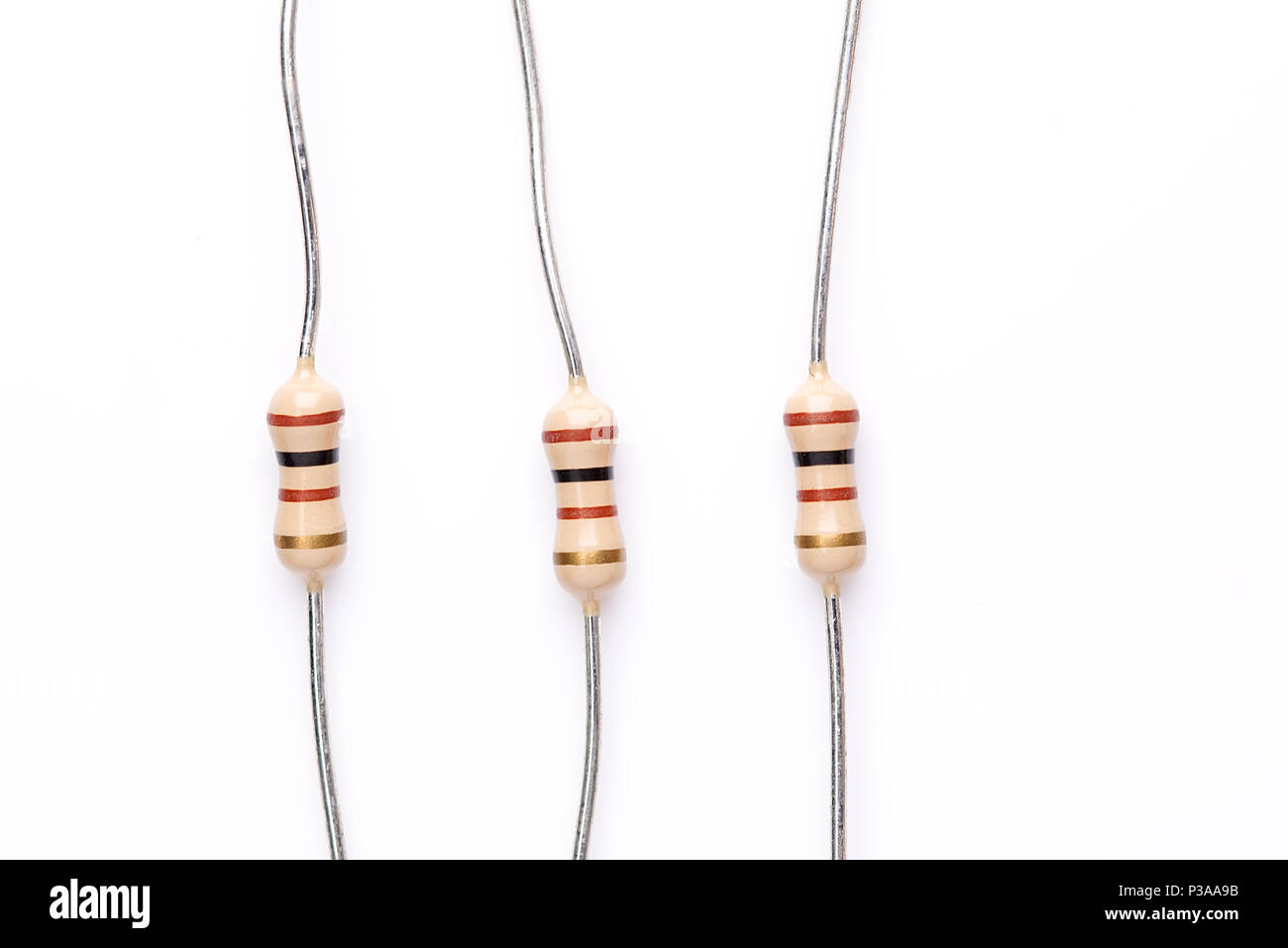 Three electrical resistors isolated on a white background. Electric ...
