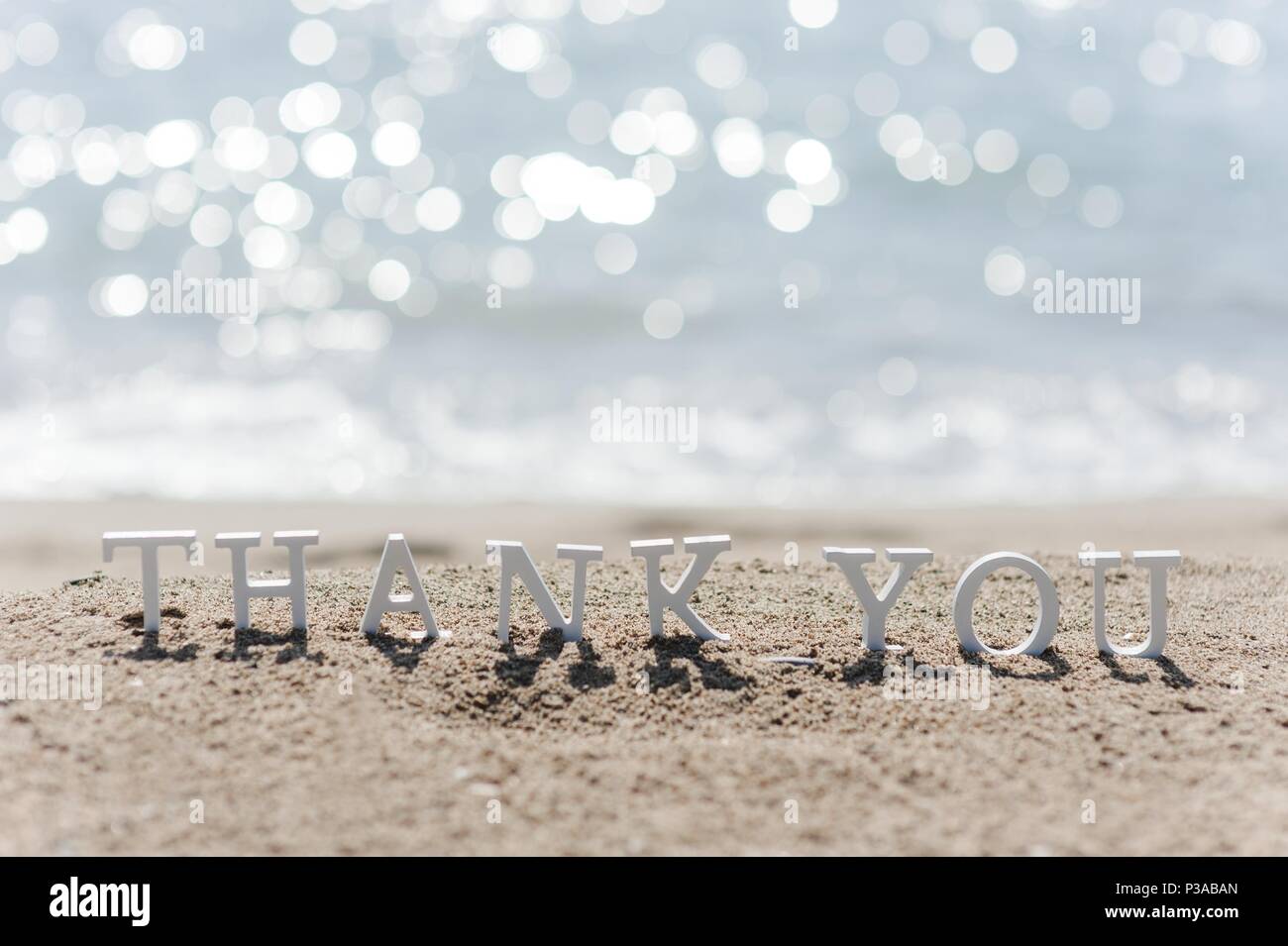 thank you word drawn on the beach sand Stock Photo - Alamy