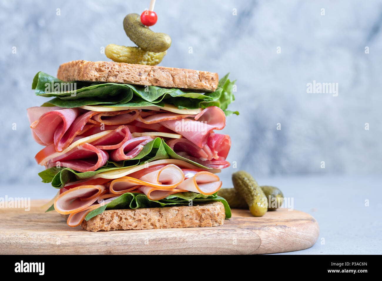 Big sandwich with ham, deli meat and vegetables Stock Photo - Alamy