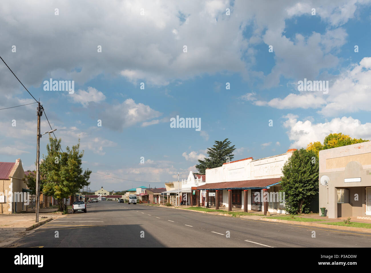 DEWETSDORP, SOUTH AFRICA - APRIL 1, 2018: A street scene, with businesses and vehicles, in ...