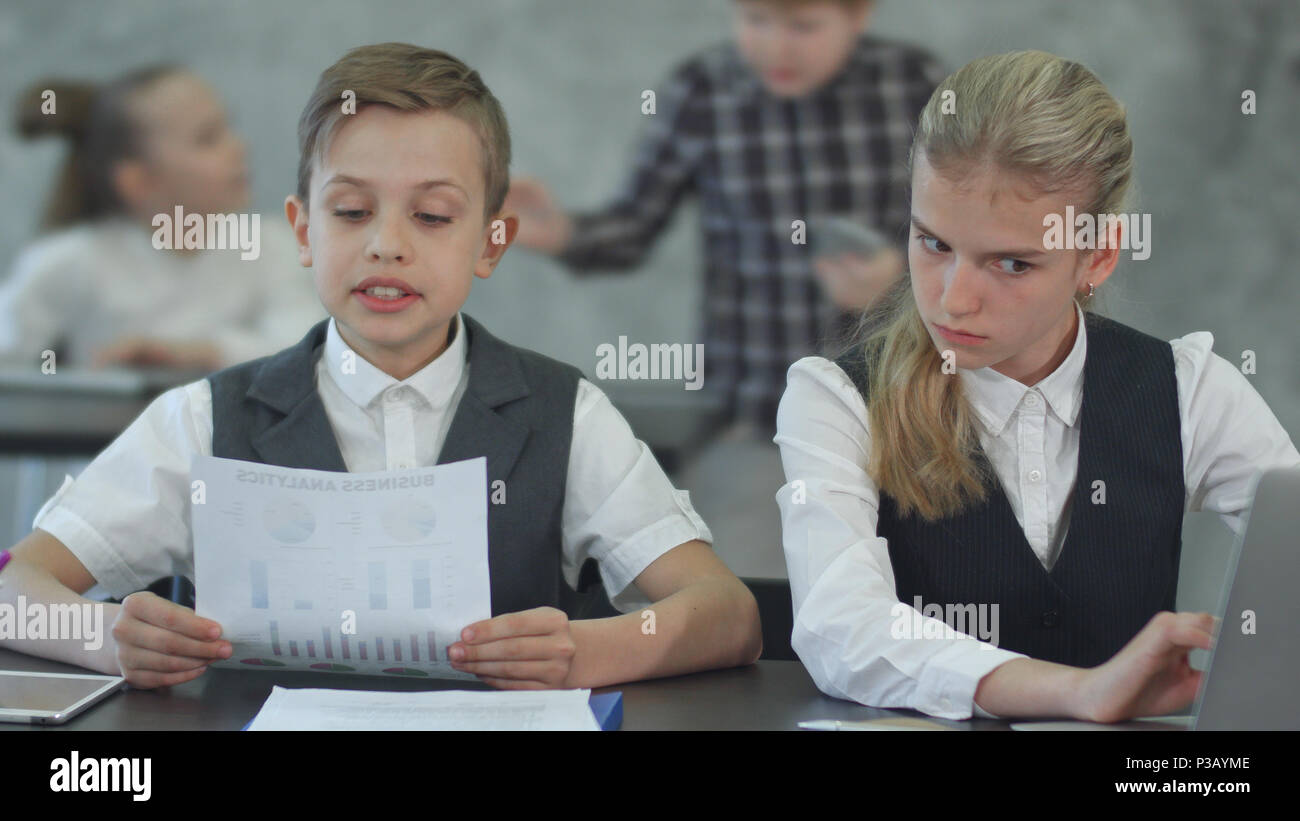 Cute children in business clothing in business center working Stock ...