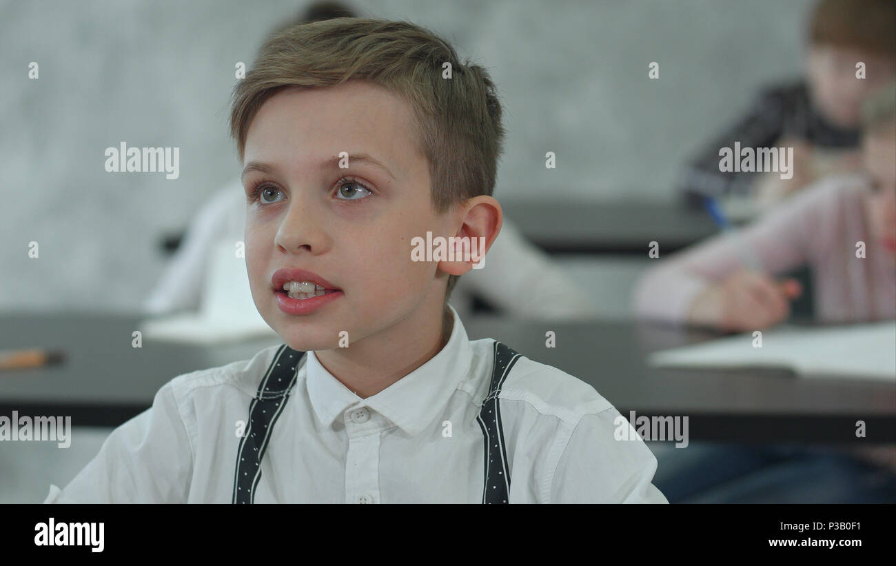 Little school boy answer a question Stock Photo - Alamy