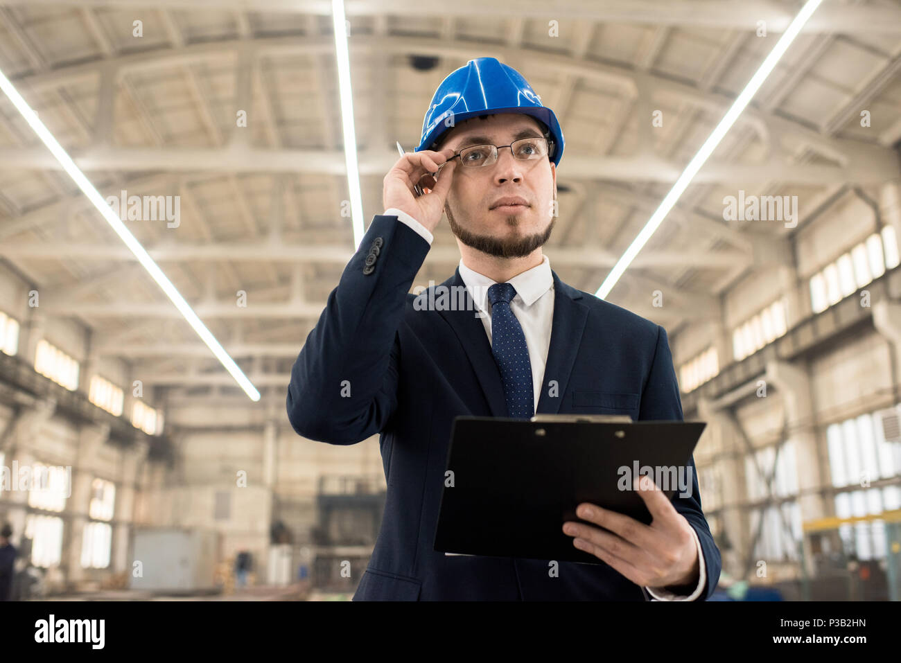 Construction inspector examining building structure Stock Photo - Alamy