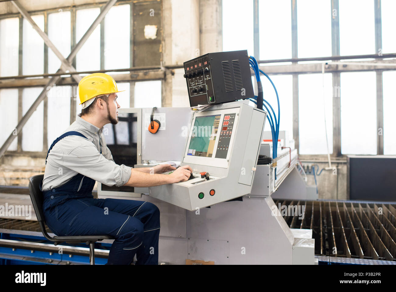 Factory operator working on control panel of manufacturing machi Stock ...