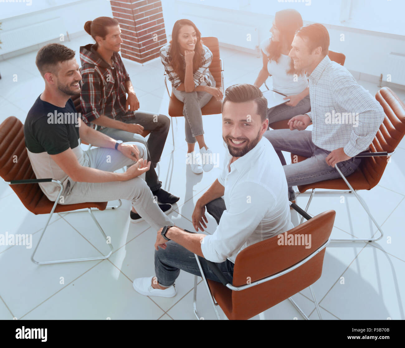 Manager and his team sitting in the office Stock Photo - Alamy