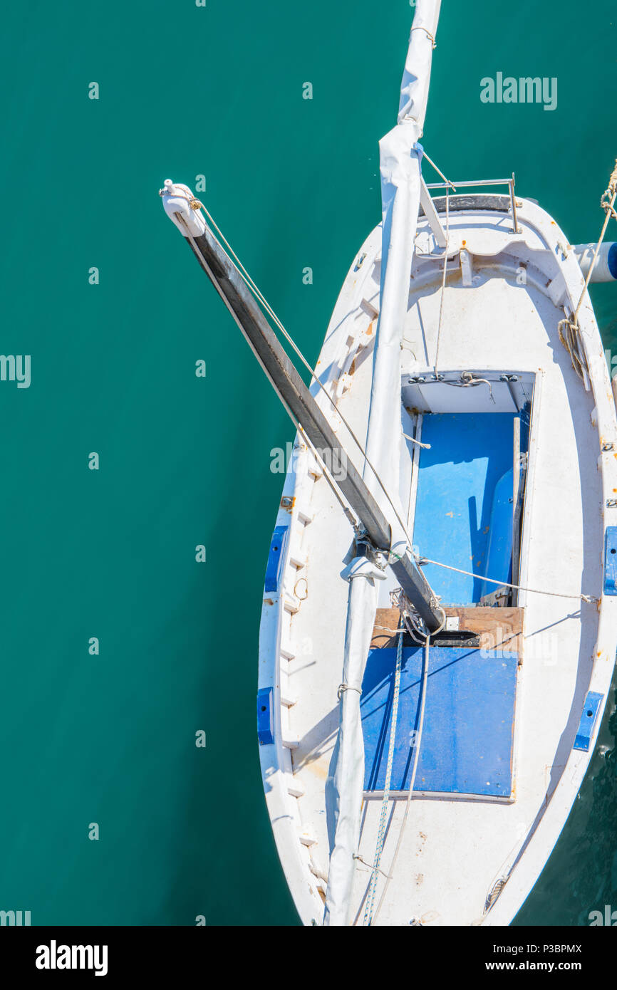 Small Beautiful Empty White and Blue Sailing Boat with Tall Mast Moored ...