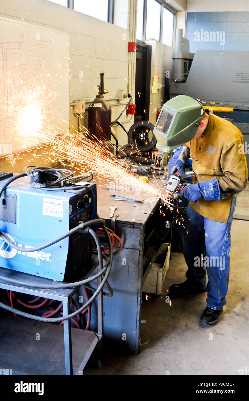 Student uses grinder to throw sparks in classroom Stock Photo - Alamy