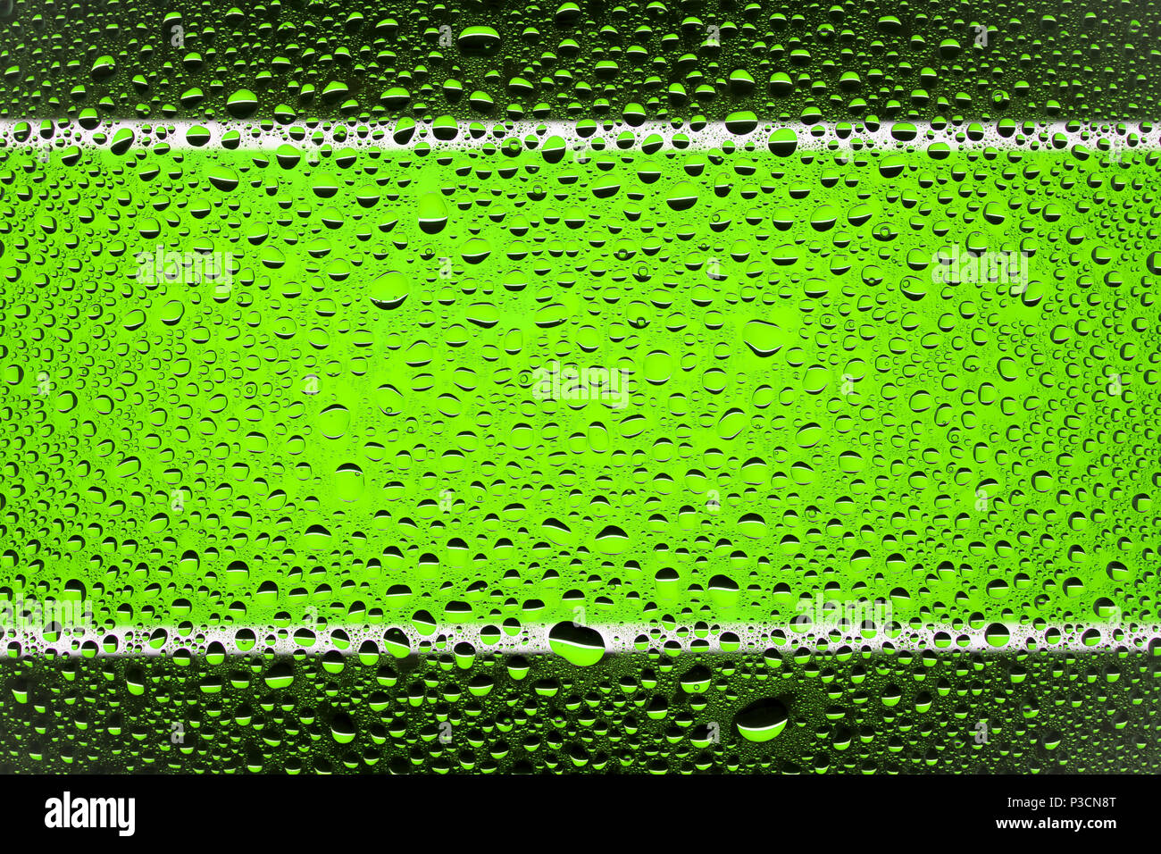 Close up of a water drops on a black and green striped background ...