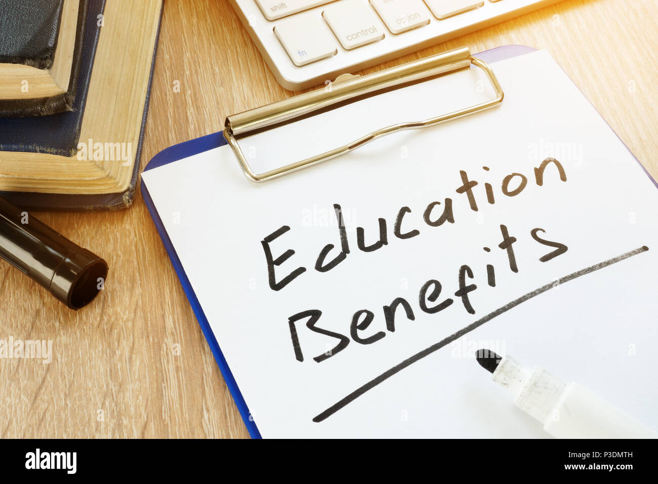 Clipboard with words Education Benefits written by hand Stock Photo - Alamy