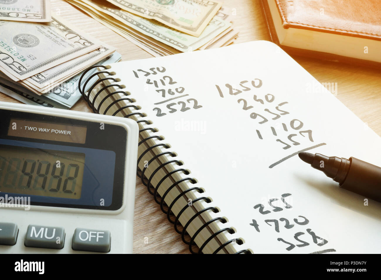 Calculator and notepad with calculations after counting money Stock ...