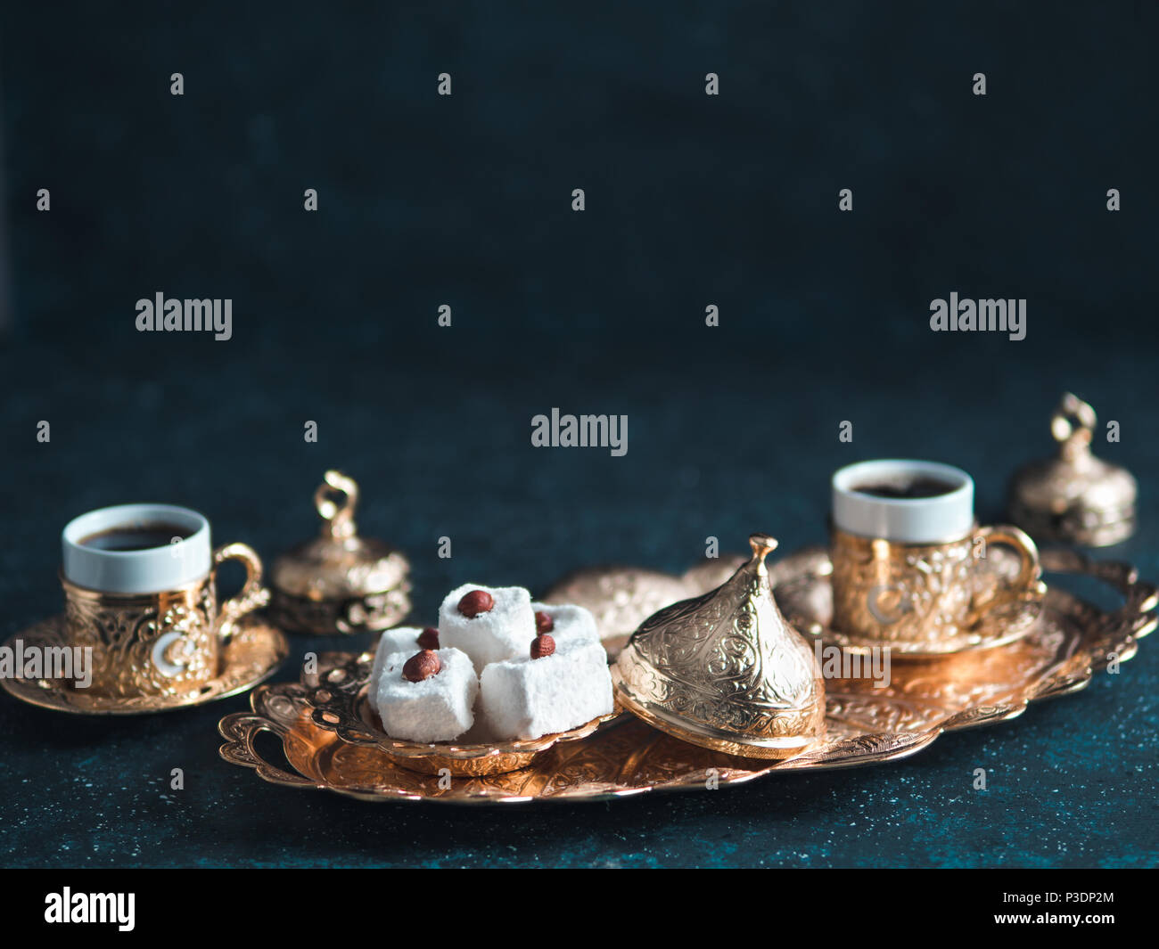 Turkish coffee with delight and traditional copper serving set on dark ...