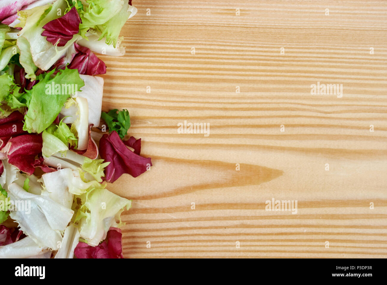 Frame of fresh green salad on wooden background. Healthy natural food ...