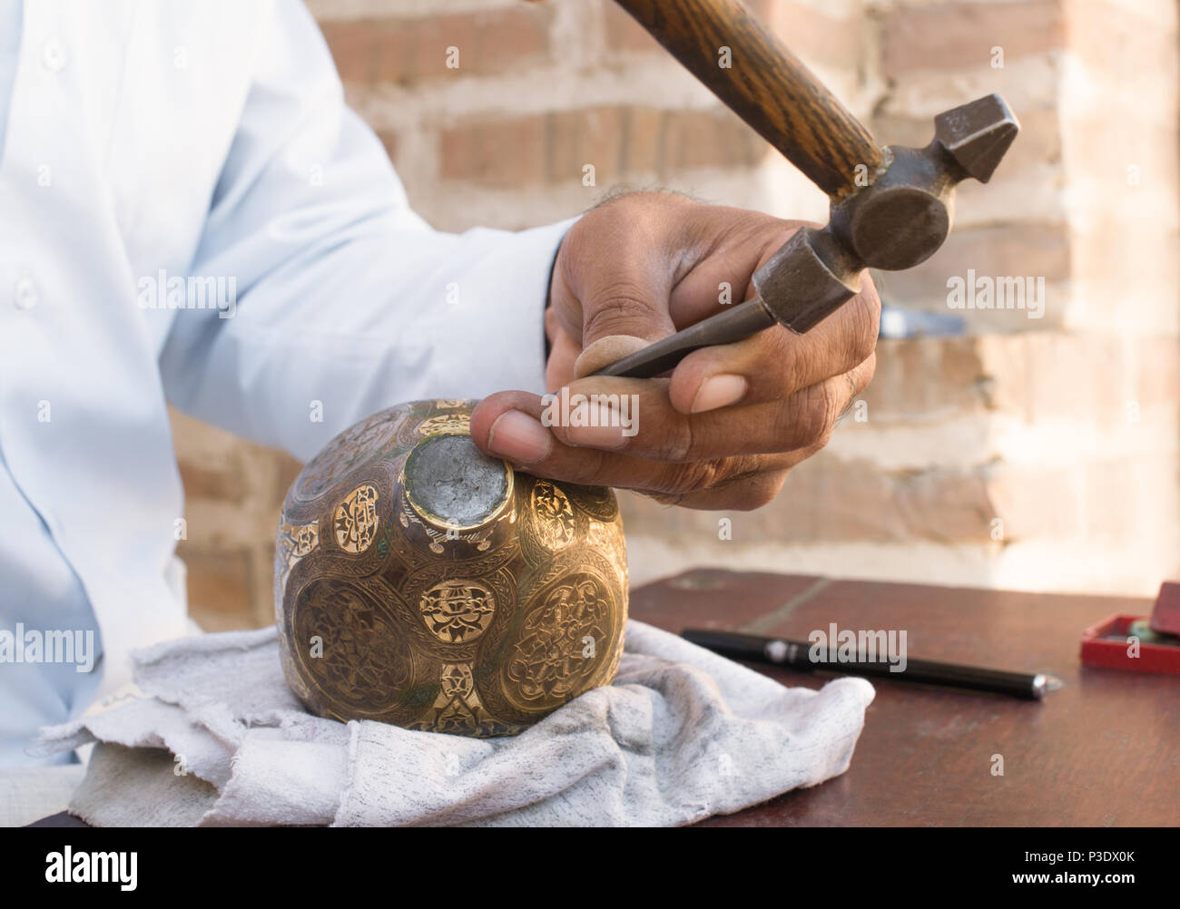 craftsman engraving patterns on the jug. masters of Central Asia ...