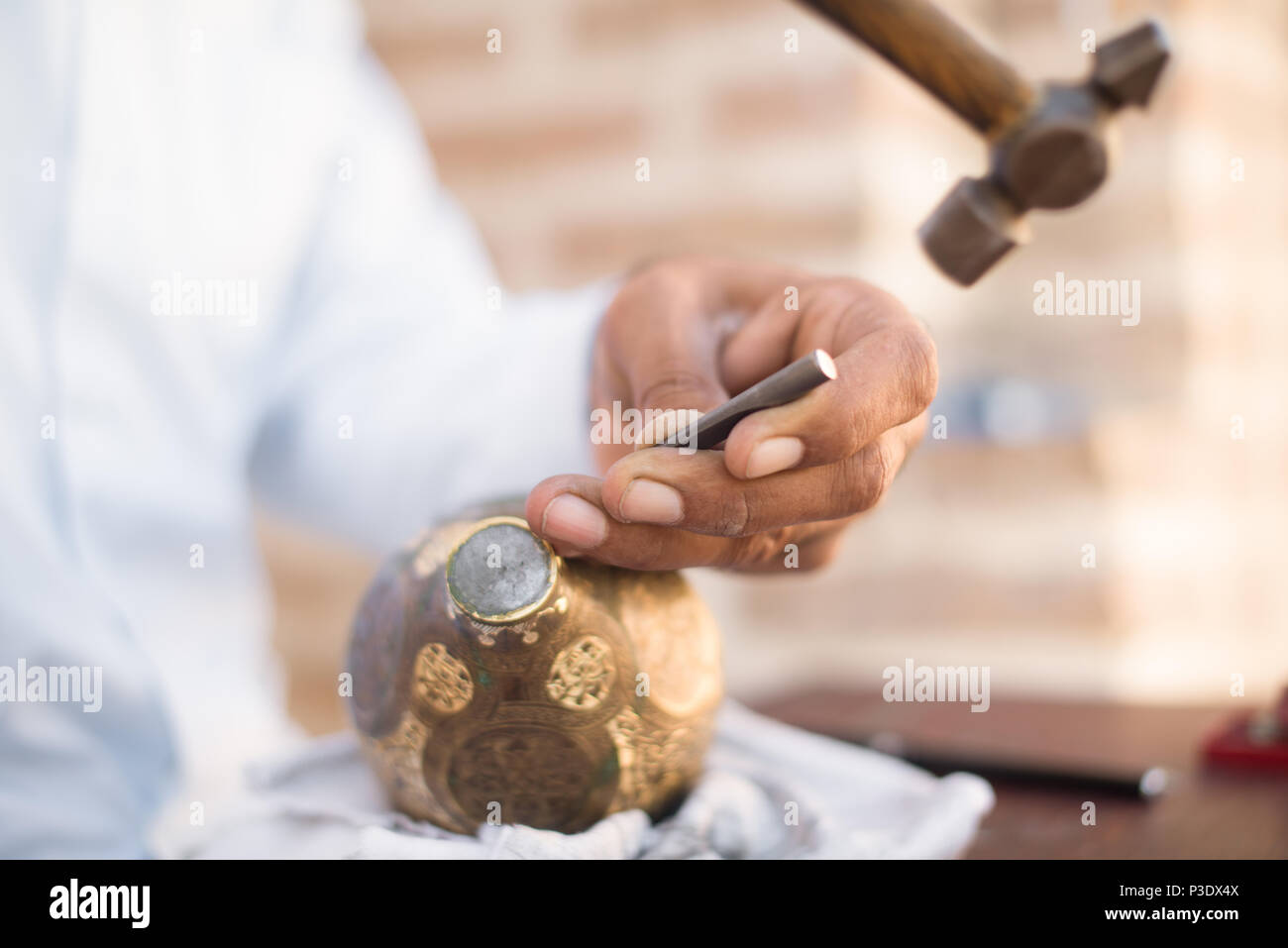 craftsman engraving patterns on the jug. masters of Central Asia ...