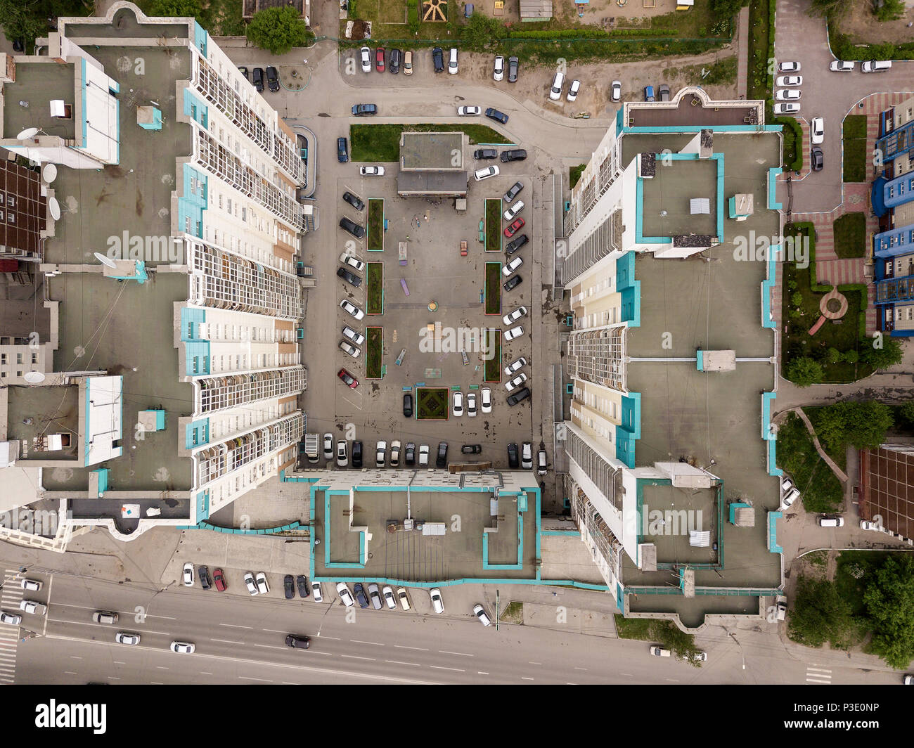 Aerial View of n-shaped tall buildangs with parking cars in the city ...