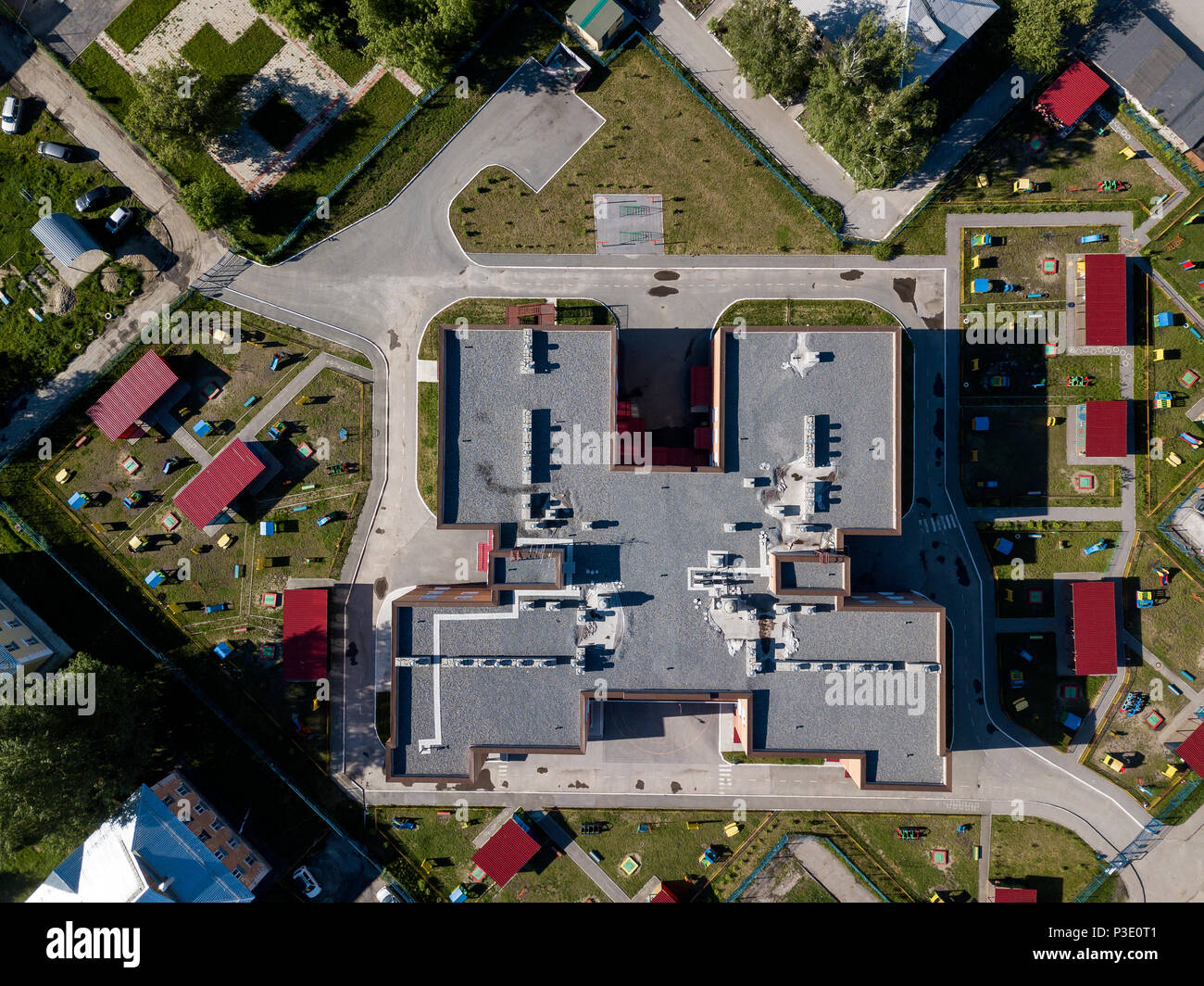 Aerial view of school for children in green area in the city. Russian ...