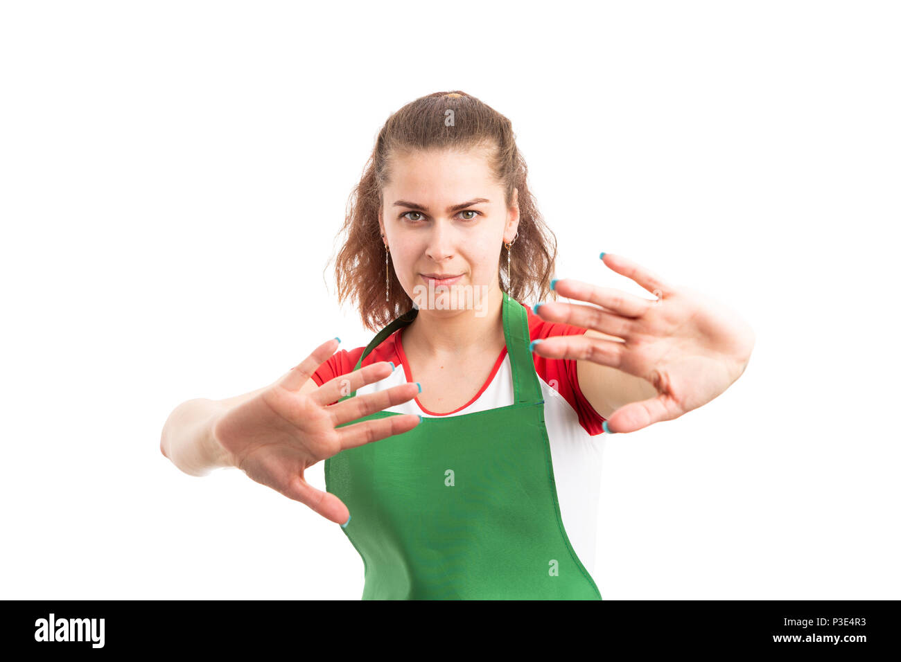 Young female supermarket worker or retail employee making defensive ...