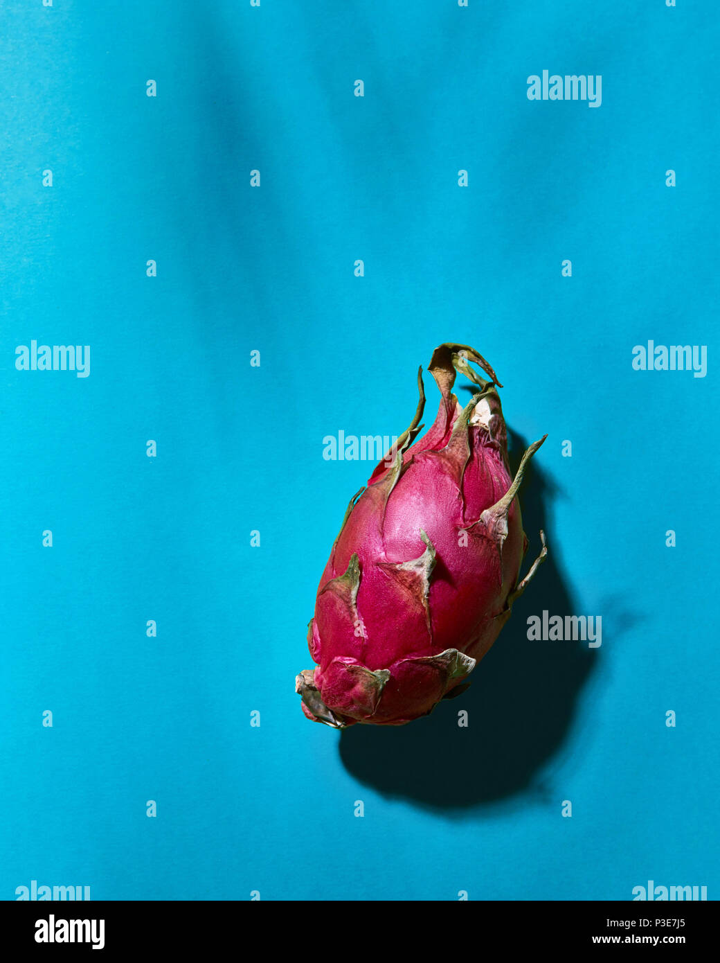 Fresh dragons fruit on a blue background shot from above Stock Photo ...