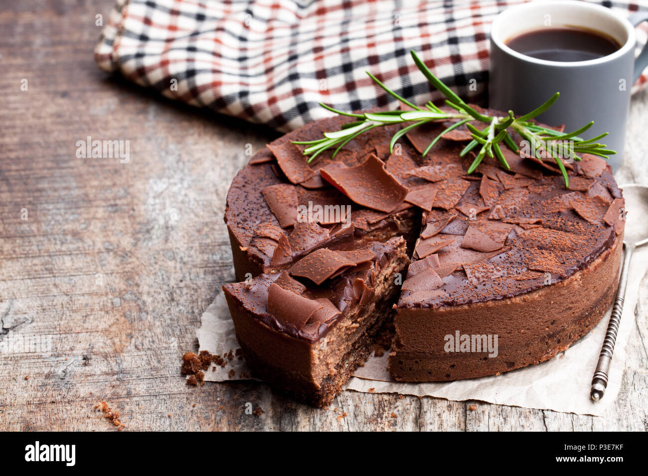 Baked belgian chocolate cheesecake with chocolate ganache on wooden ...